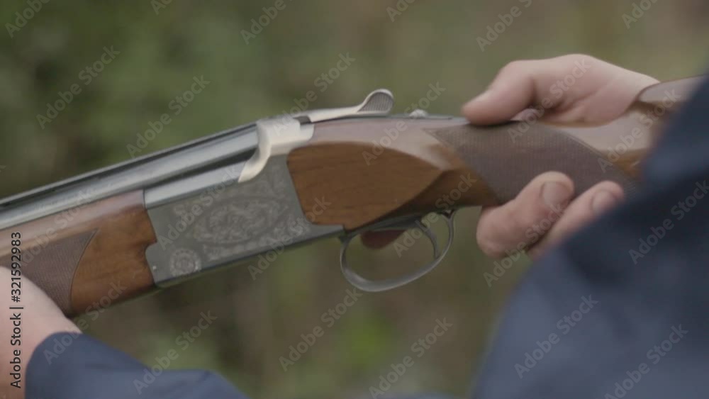 Loading a double barrel over under shotgun and closing the breech Stock ...
