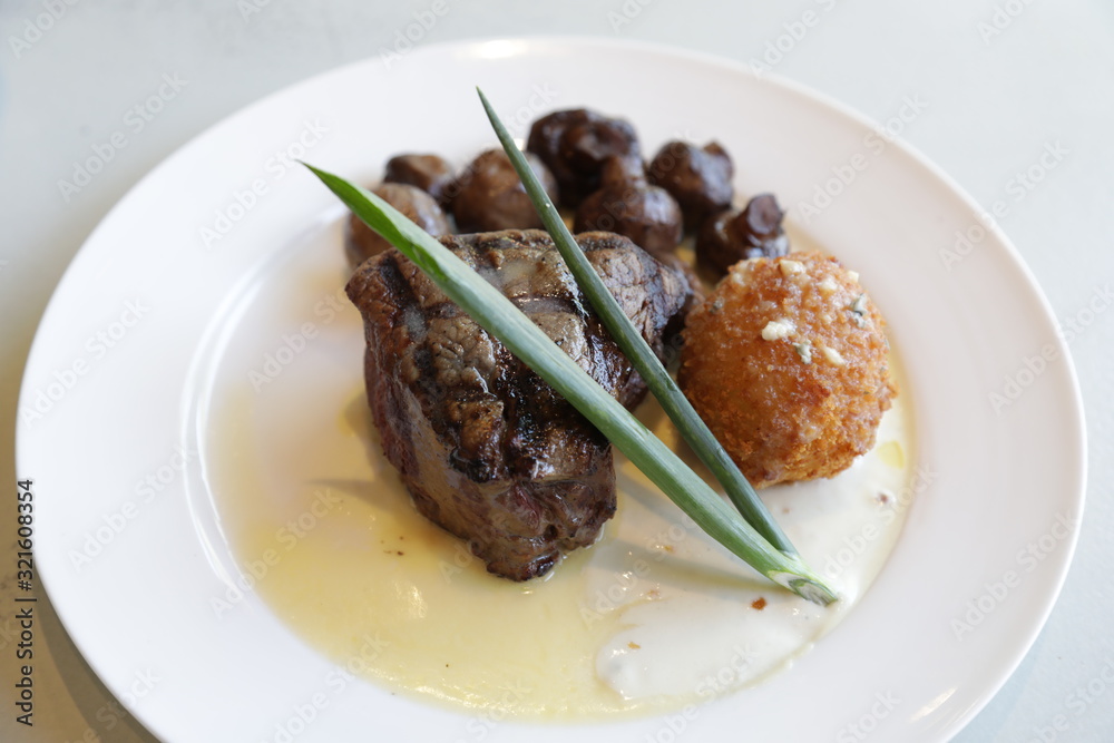 prime cut beef sirloin steak with sauteed mushrooms and hush puppy ...