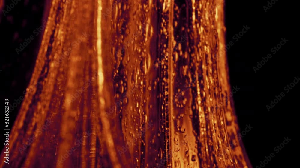 Colored sticky mucus stretches from top to bottom on the dark ...