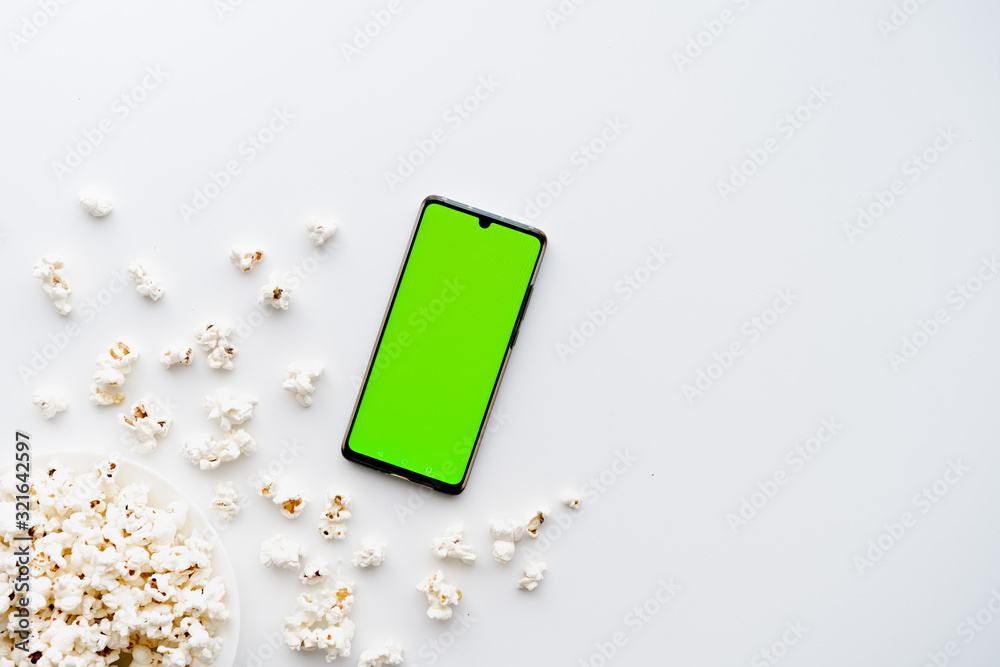 Smartphone green screen mockup and popcorn. Isolated on white ...