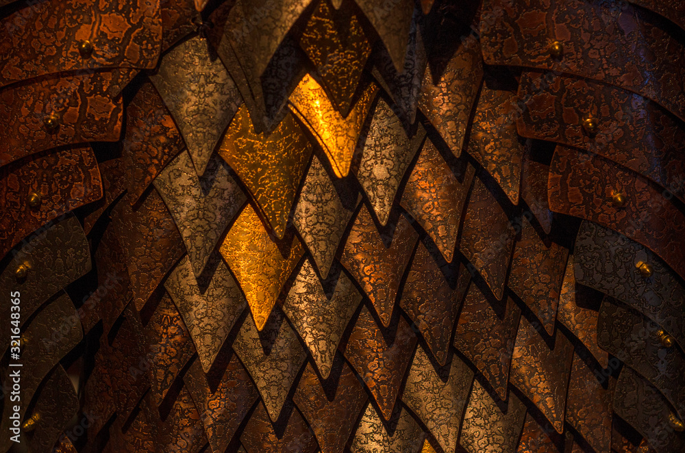 Metal scales of different shades close up. Background with golden ...
