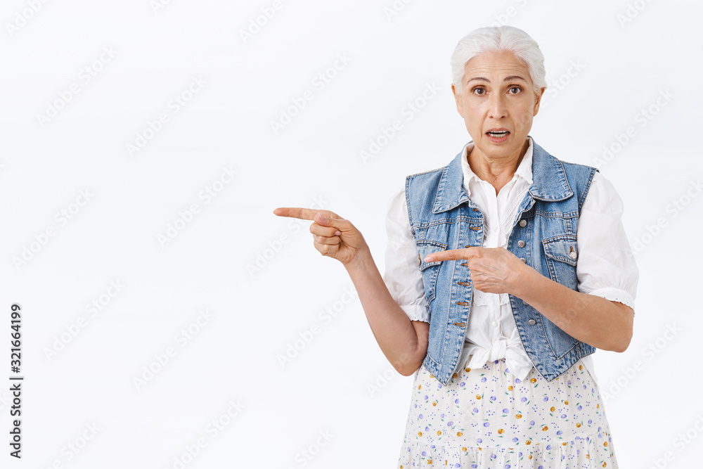 Doubtful, skeptical, indecisive senior woman, grey hair, wear denim ...