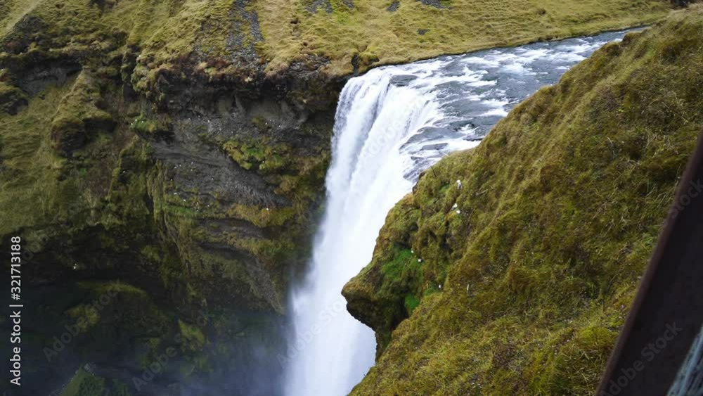 a breathtaking Skogafoss waterfall is one of the most famous waterfalls ...