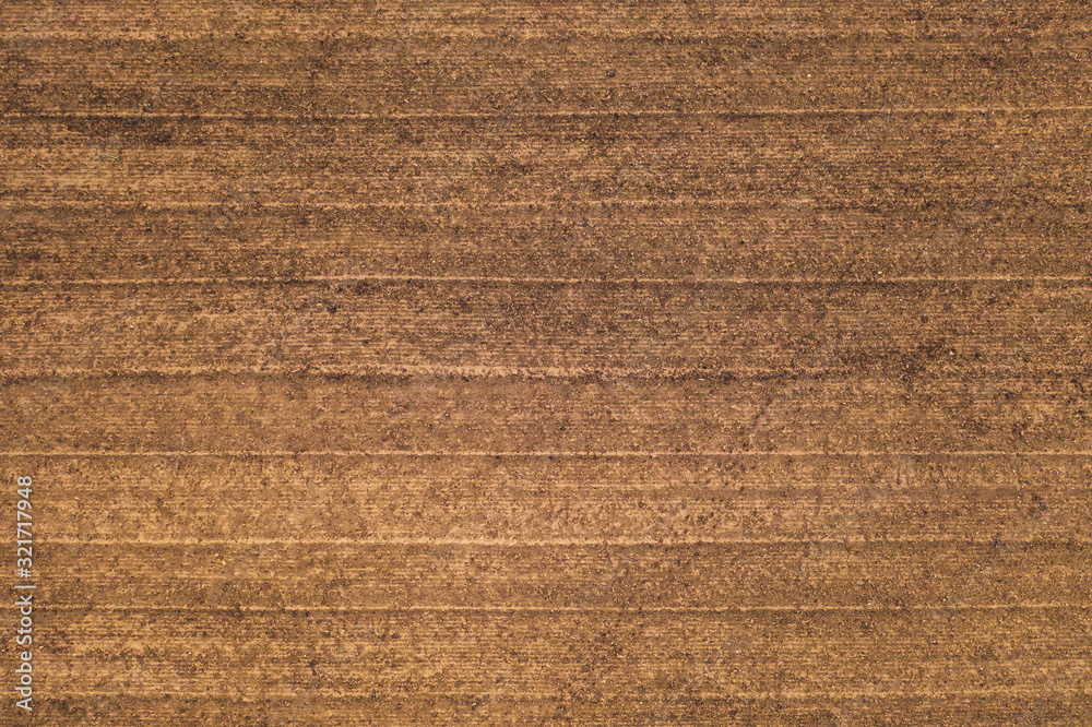 Textured ground surface with parallel lines from cultivator, top view ...