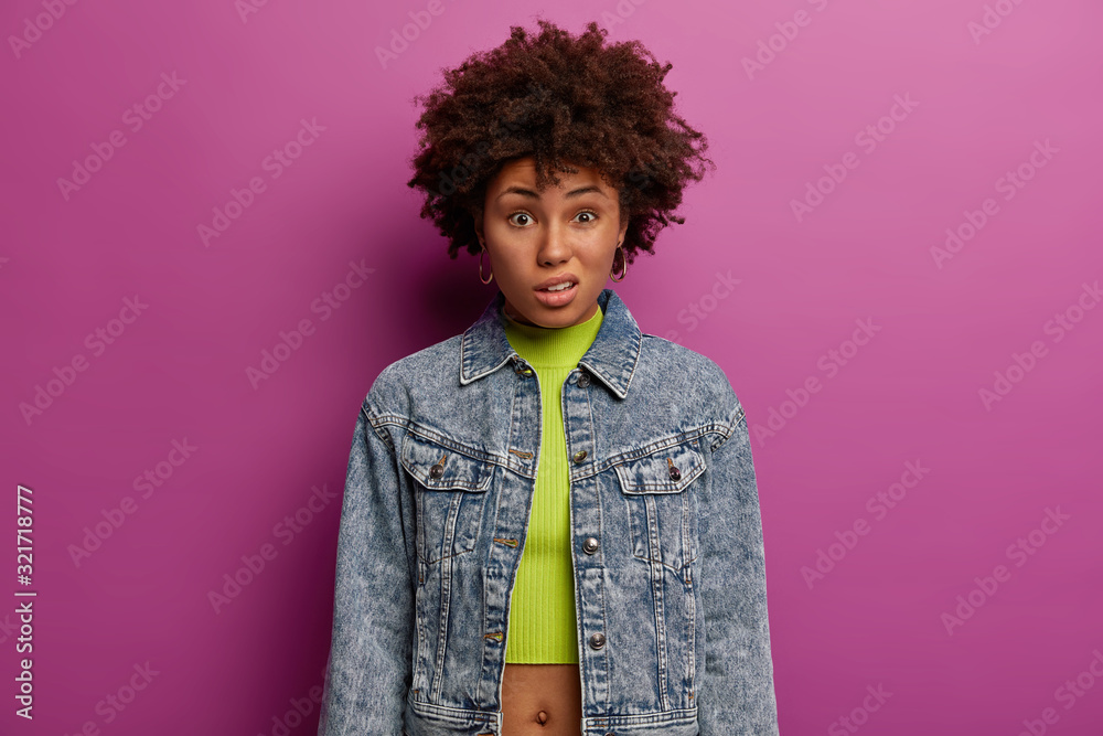 Waist up shot of displeased woman smirks face, sees something ...