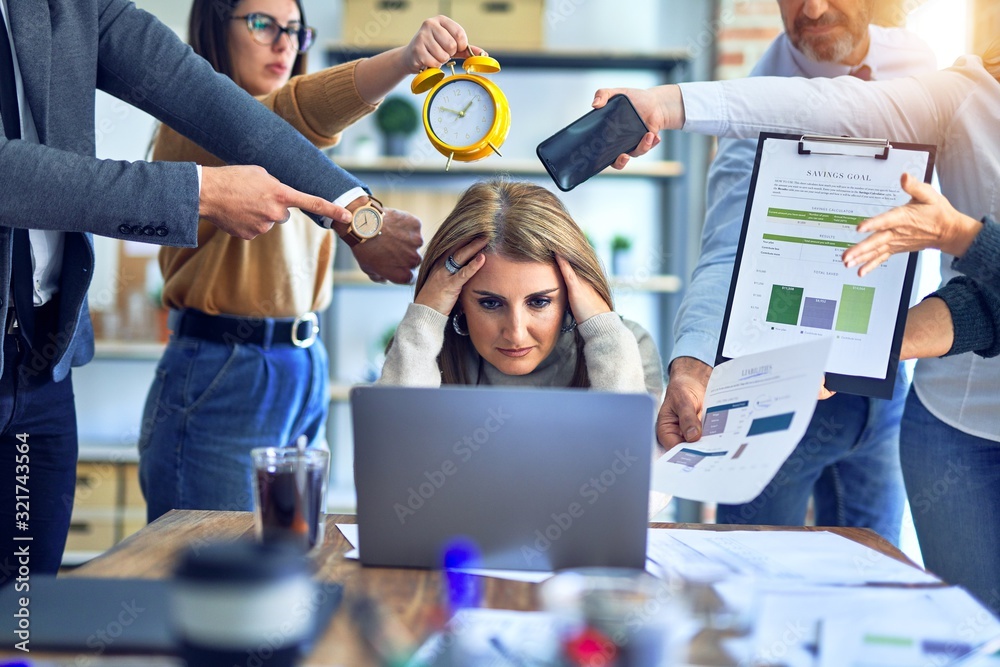 Group of business workers working together. Partners stressing one of ...