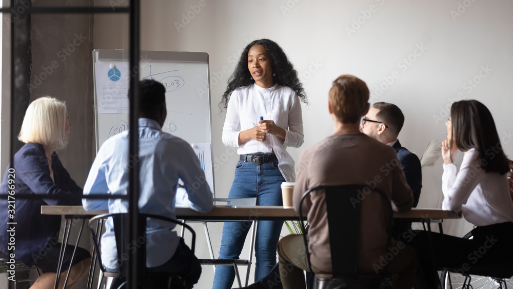 African ethnicity woman presenter makes presentation for multiethnic ...