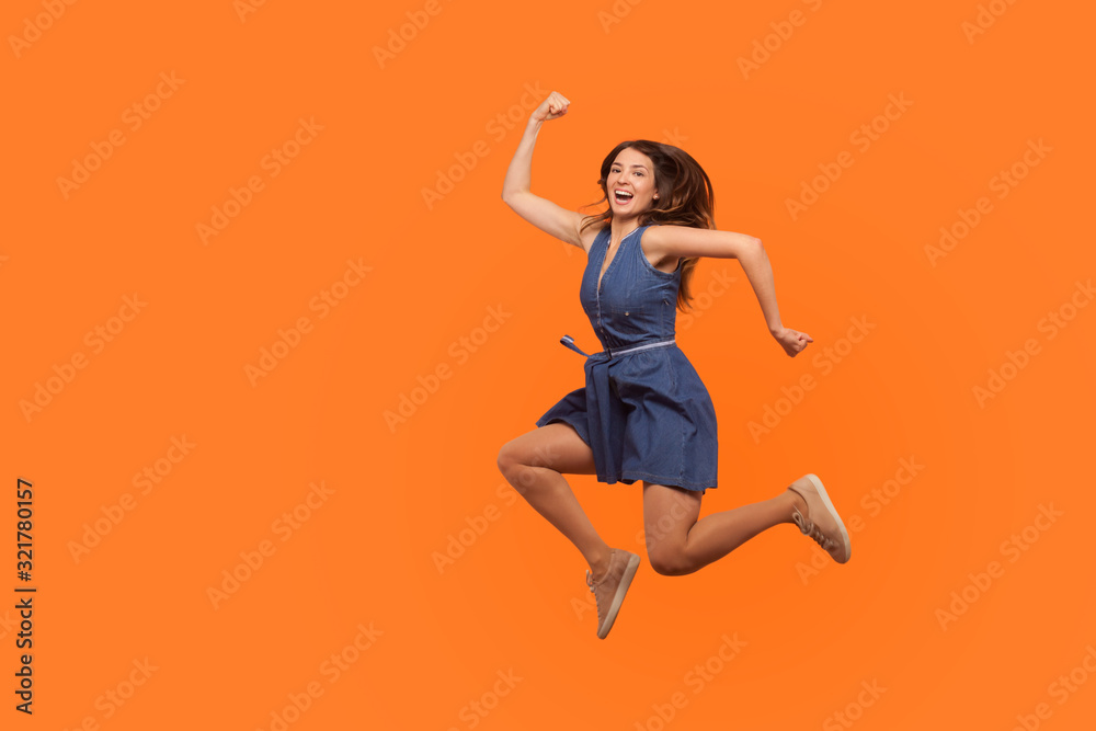 Leap to success. Full length of excited energetic motivated brunette ...