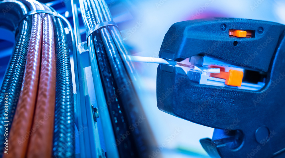 Crimping pliers for wire tips on the background of bundles of different ...
