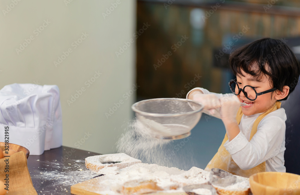 Little boy in kitchen.Cute boy wears a chef hat and apron. Stock Photo ...