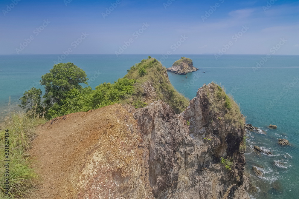 view of peak mountain with blue-green sea and blue sky background, top ...