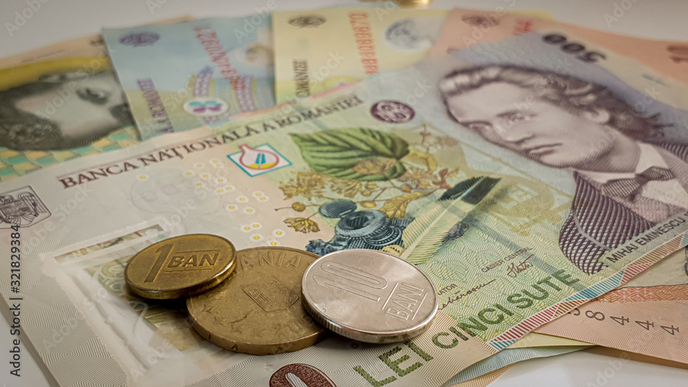 Fanned out Romanian Lei bank notes low down diagonal view with 3 coins ...