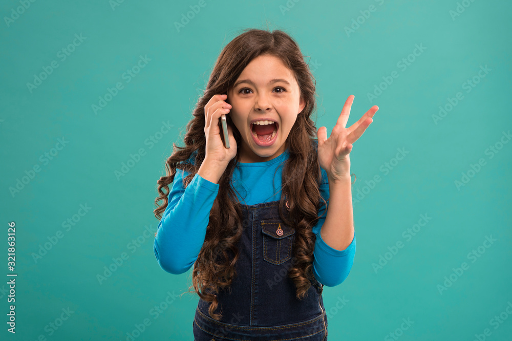 Freaking out. Modern gadget. Upbringing and development. Little girl ...