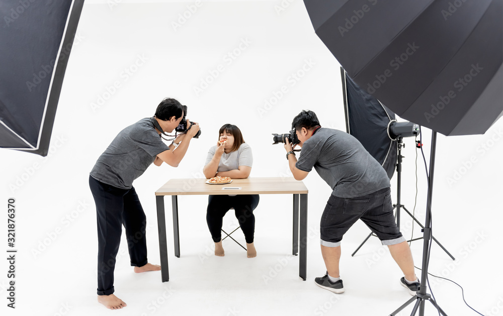 Asian photographer 2 men taking photos of protrait female model who is ...