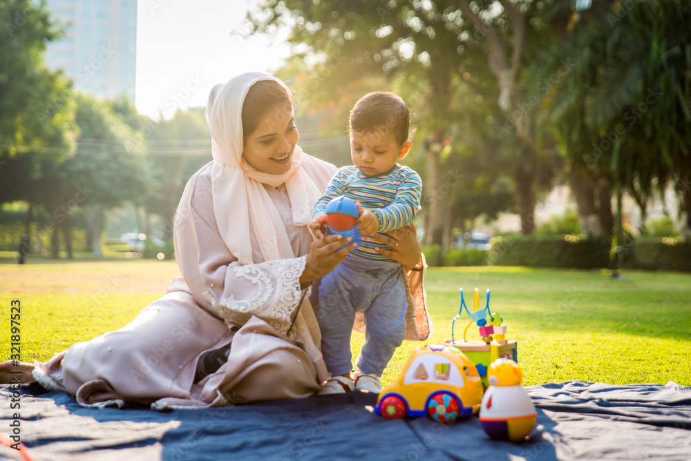 Arabic mom and her little toddler playing outdoors Stock Photo | Adobe ...