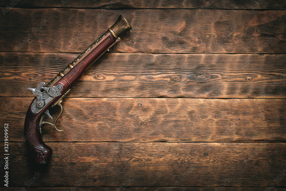 Poster Old musket gun on pirate desk table concept background with copy ...
