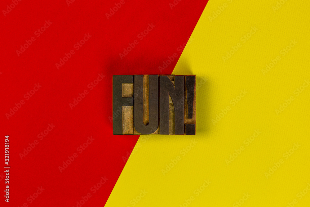 written fun! with wooden printing characters on a two-tone background ...
