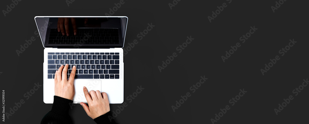 Person using a laptop computer on a solid color background Stock Photo ...