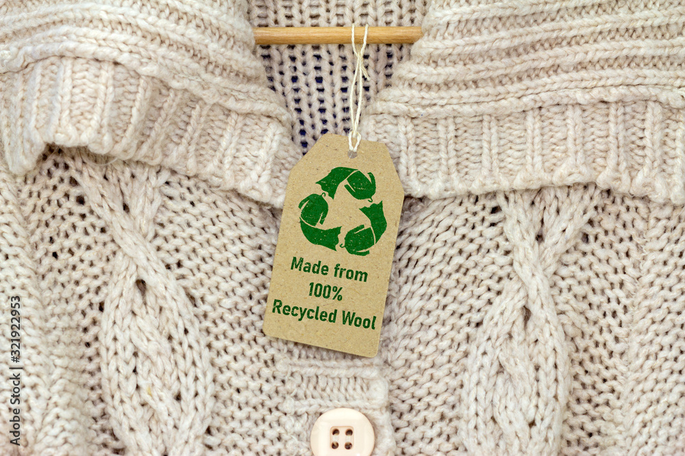 recycle wool text and recycle reuse symbol on wool jumper tag ...