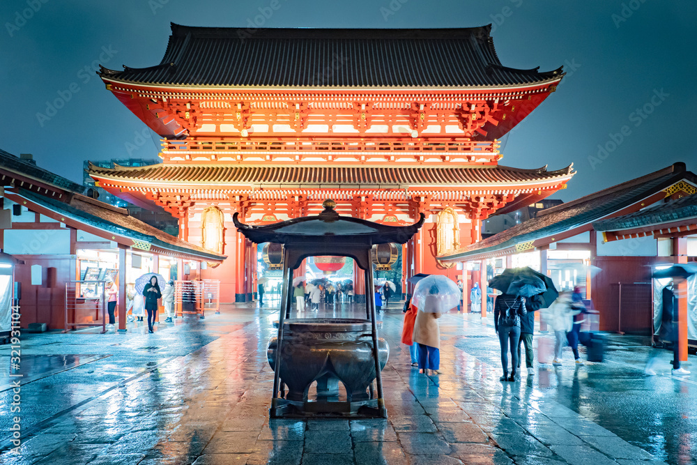Tokyo. Japan. Asakusa Temple. People walk in the rain at the temple of ...