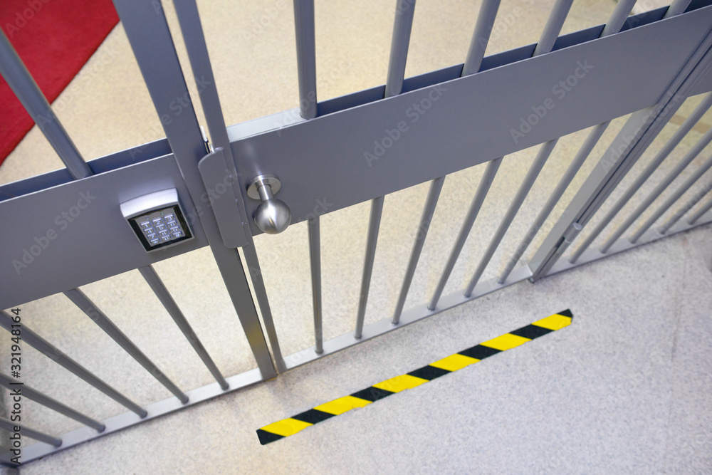 Metal bar door in a prison. Electronic lock with keypad and steel ...