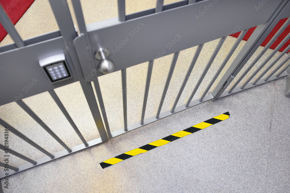 Jail cell door. Metal bars in prison. The lock and steel bobble handle ...