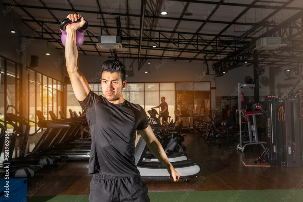 Fitness man doing a weight training by lifting heavy kettlebell Stock ...