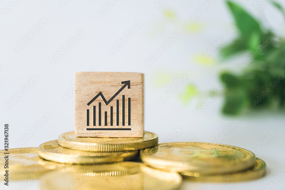 Graph rising up growht exponencial sign on wooden cube with objects ...