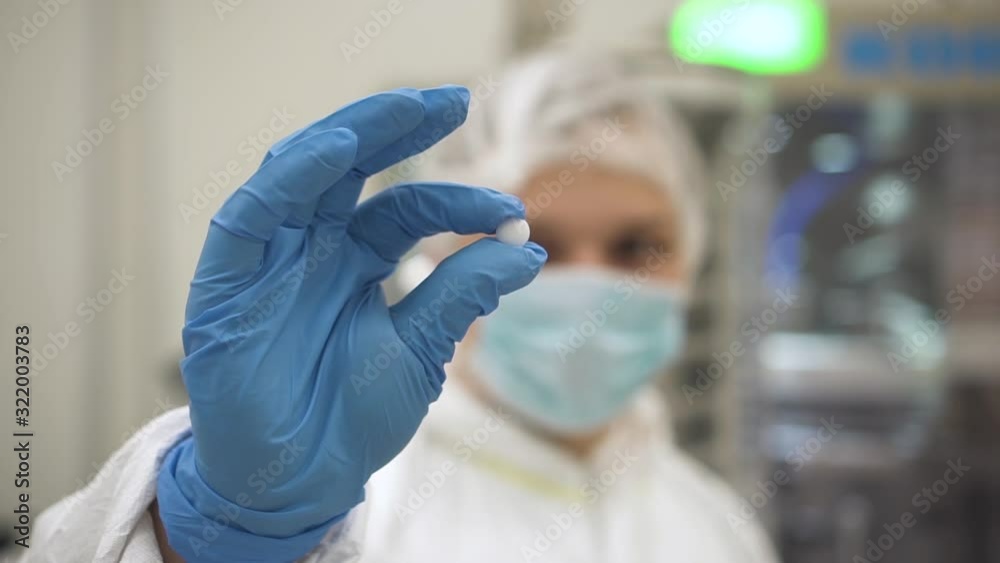 drug pharmaceutical factory worker holding tablet pill and posing ...