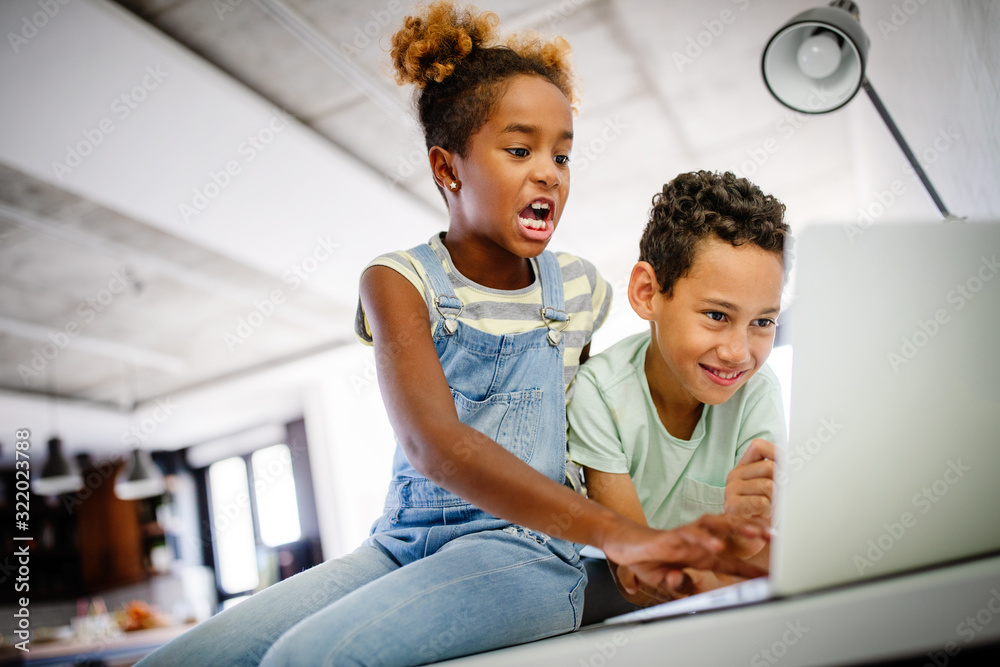Kids, technology concept. Happy children using laptop to learn, play ...