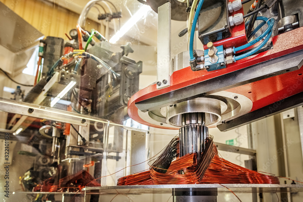 Robot machine that winds and inserts the coils into the armature of an ...