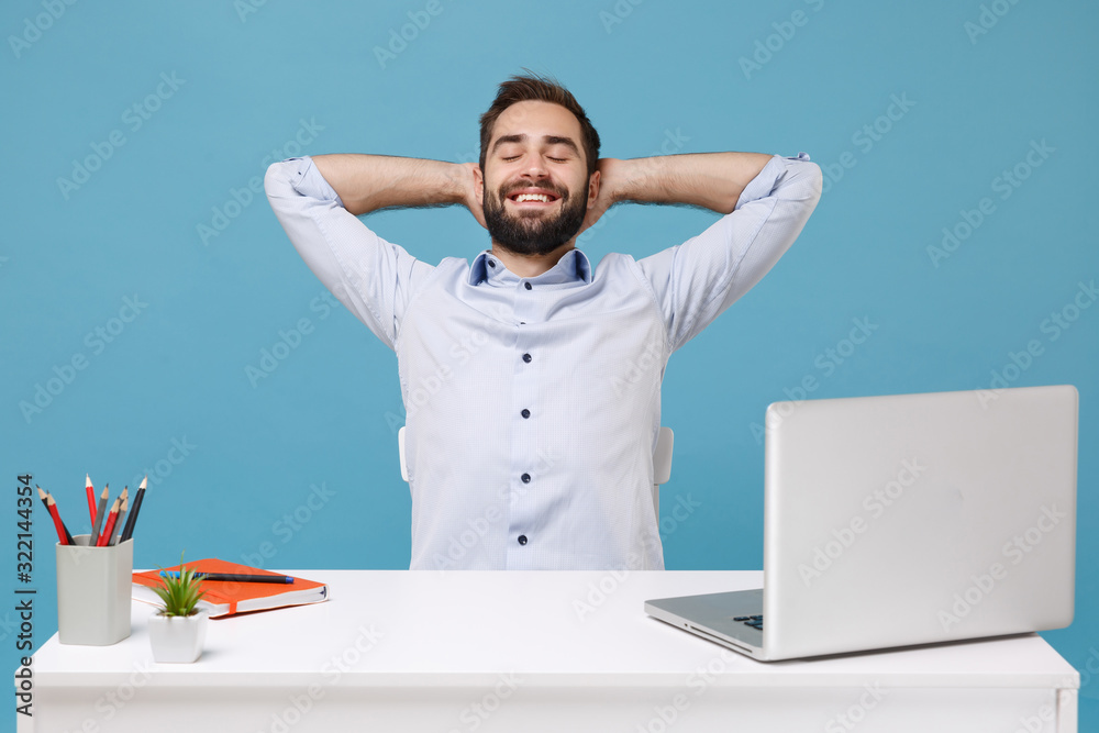 Relaxed young man in light shirt sit work at desk with pc laptop ...