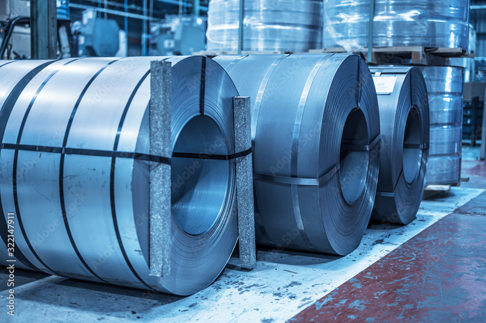 Industrial background. Big size steel coil stored inside industrial ...