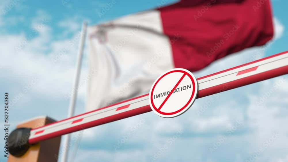 Closing boom barrier with stop immigration sign against the Maltese ...