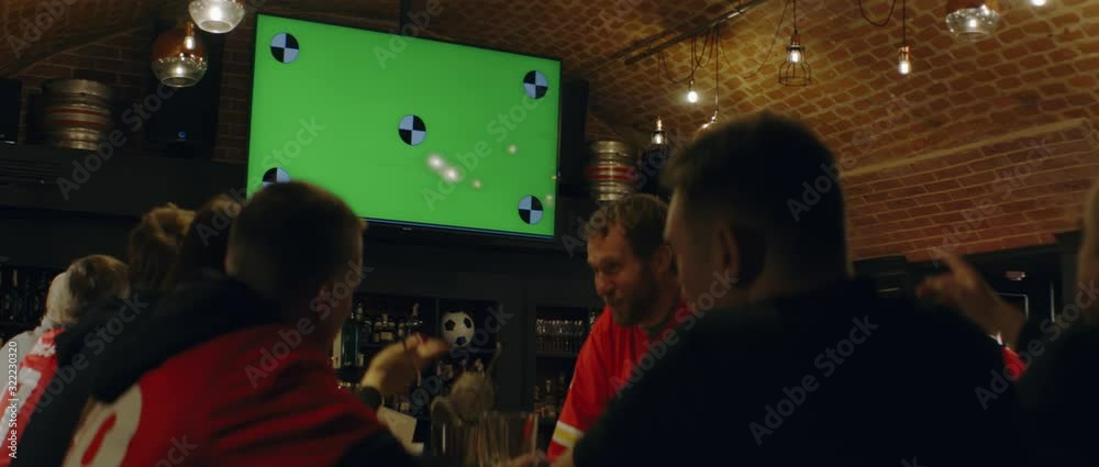HANDHELD Model released, fans watching a game on a large TV in a sport ...