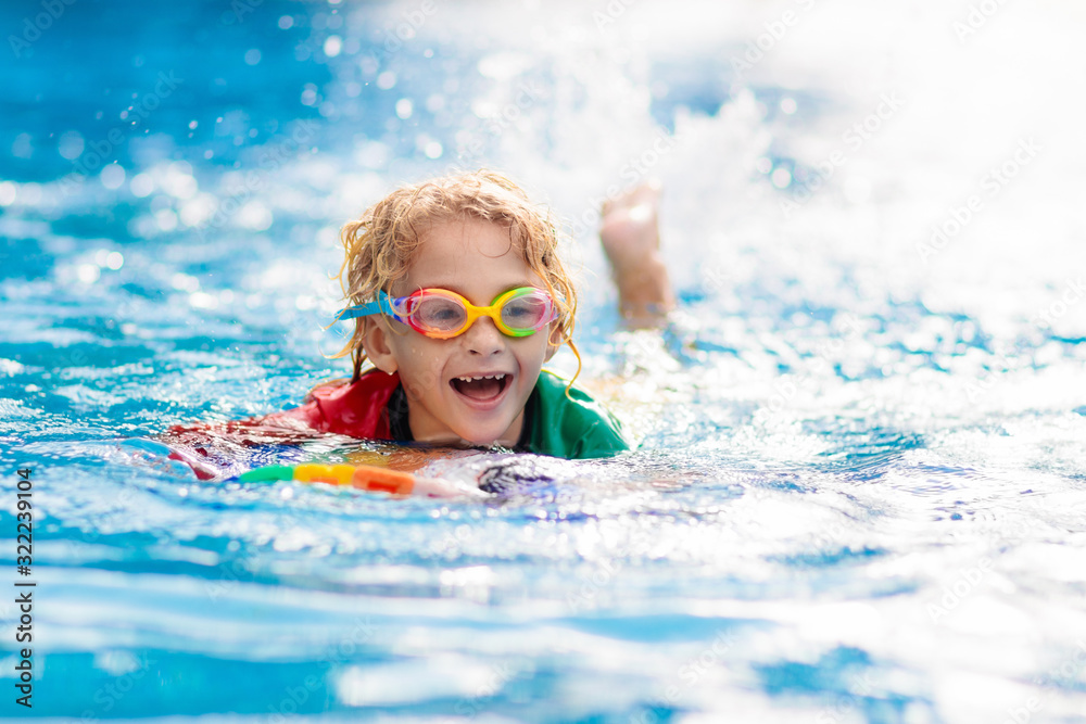 Child learning to swim. Kids in swimming pool. Stock Photo | Adobe Stock