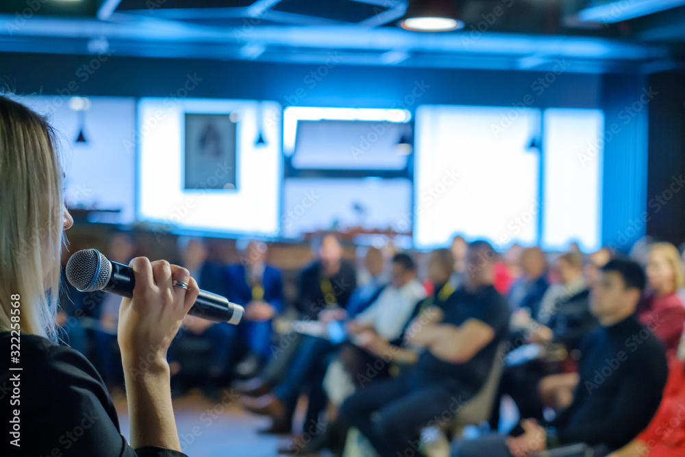 Female presenter speaks to audiences Stock Photo | Adobe Stock