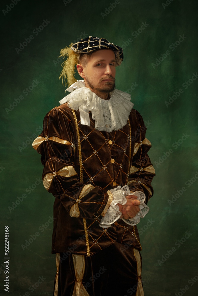 Posing thoughtful. Portrait of medieval young man in vintage clothing ...
