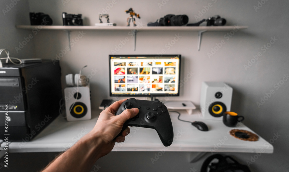 Cloud gaming: a gamepad in a male hand against the background of a ...