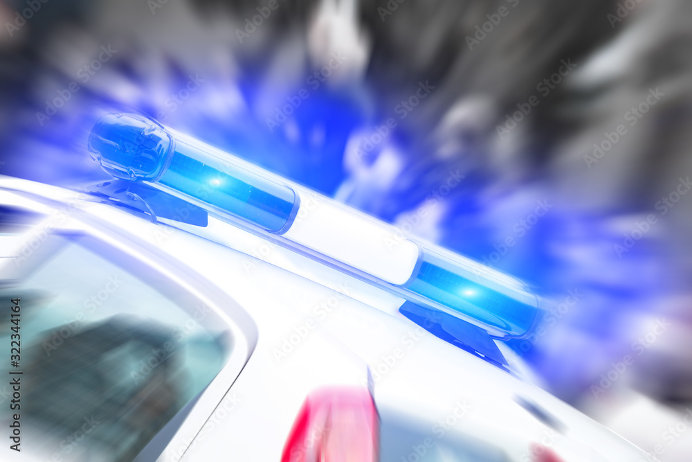 Police car with blue lights on the crime scene in traffic / urban ...