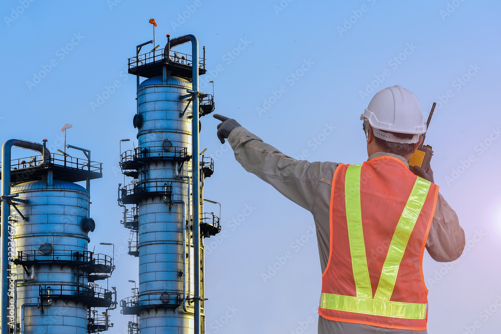 Worker in Oil Refinery discussion and pointing for inspection by hand ...