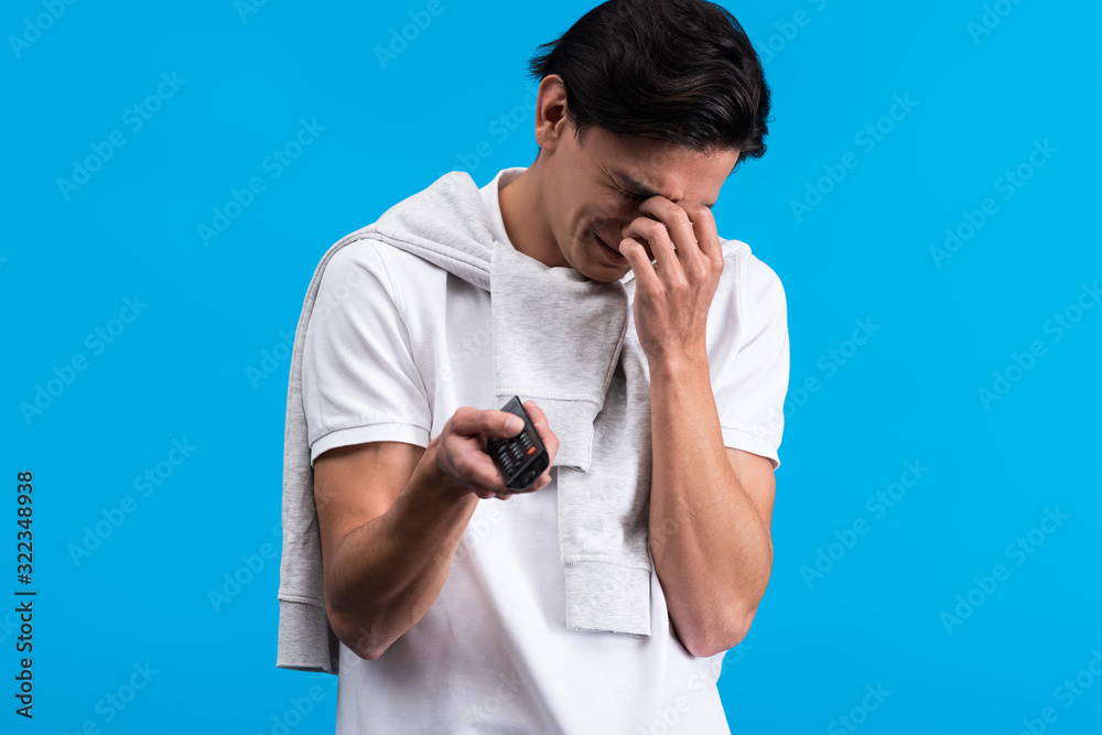 sad man crying while watching tv with remote controller, isolated on ...