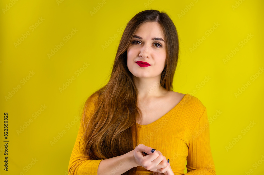 Nice Brunette Girl With Long Hair With A Smile In A Yellow Jacket Rejoices On A Yellow