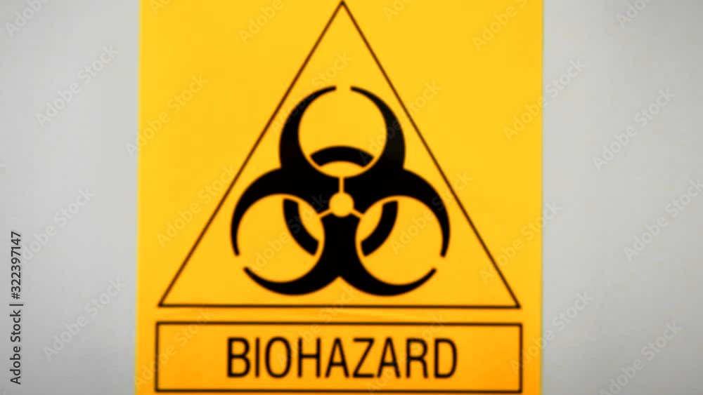 Biohazard sign on laboratory wall. Caution sign for authorised ...