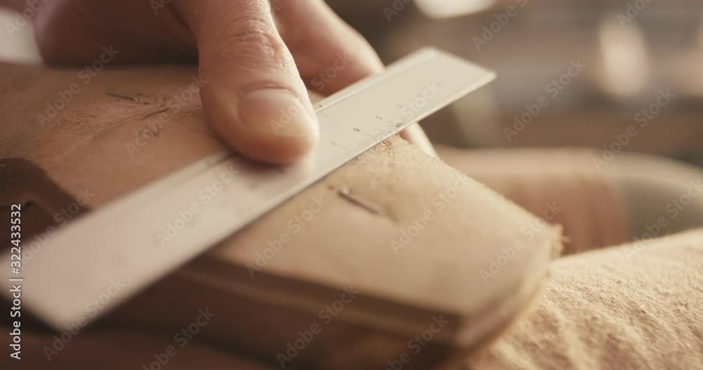 Traditional bespoke shoemaker measuring marking leather insole on ...