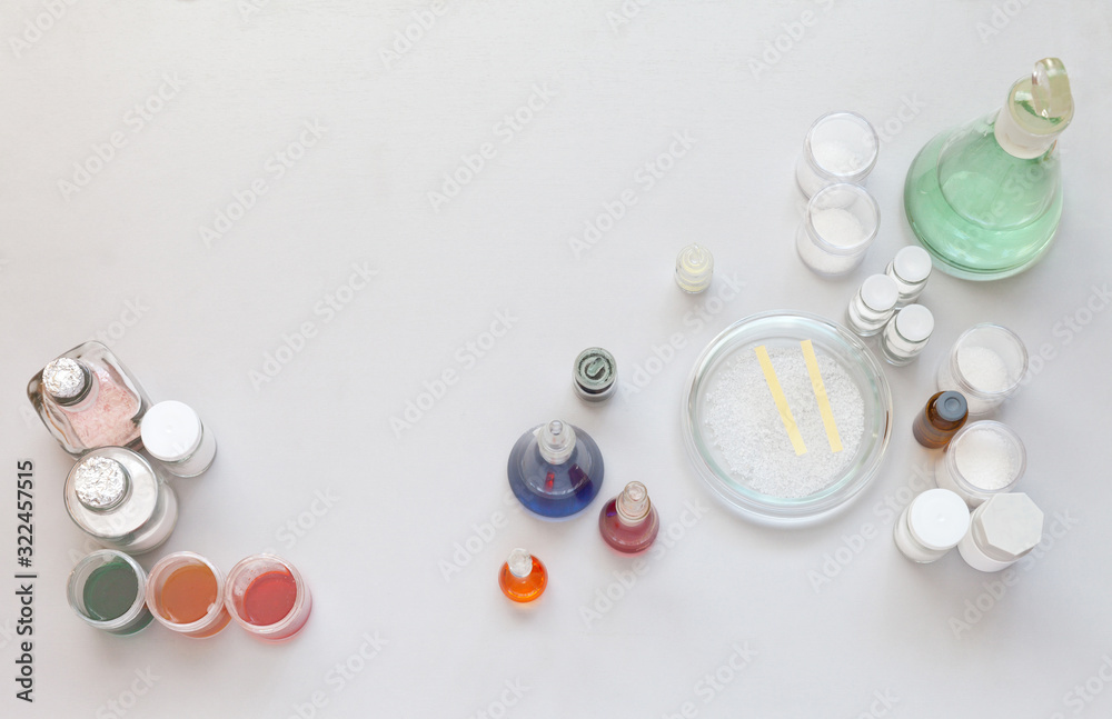 Top view on a chemical laboratory table with color solutions in flasks ...