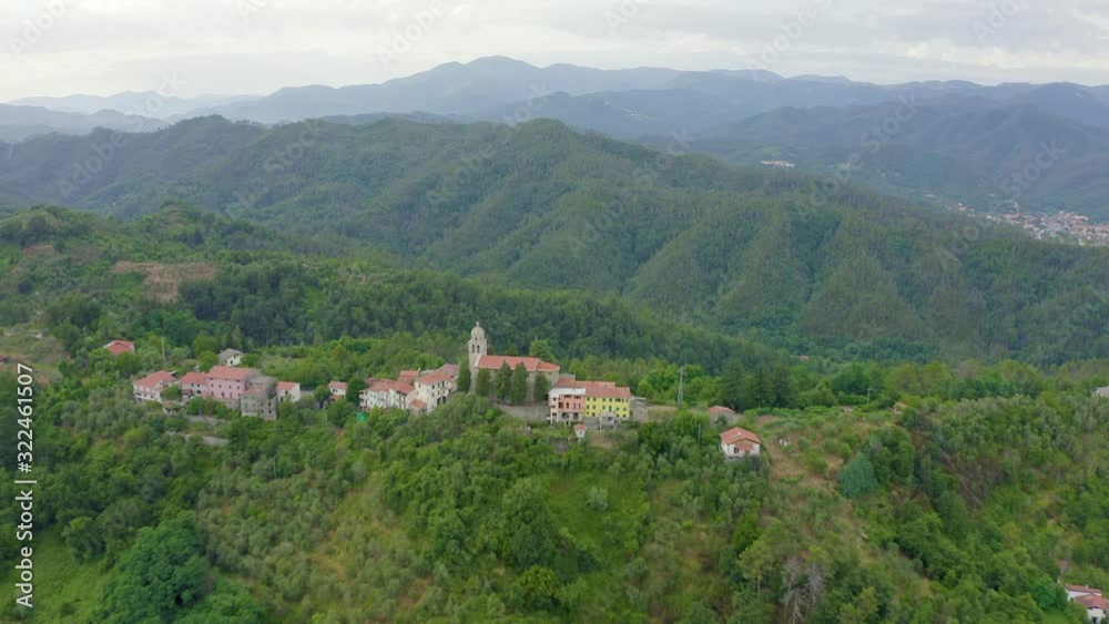 Italy. Forest covered mountains and villas. Church of San Michele ...