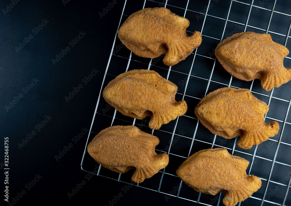 Traditional Malaysian cake called "kuih bahulu or baulu" in fish shape ...