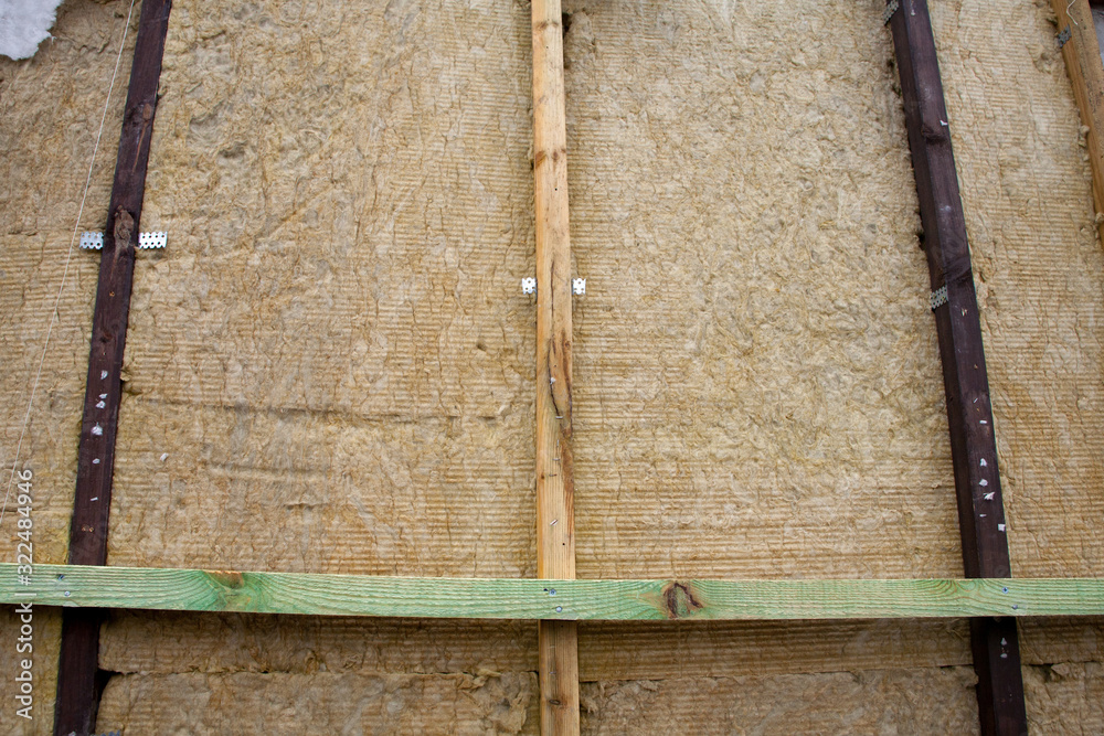 warming the walls of a stone house with a stone wool heater. Ecological ...