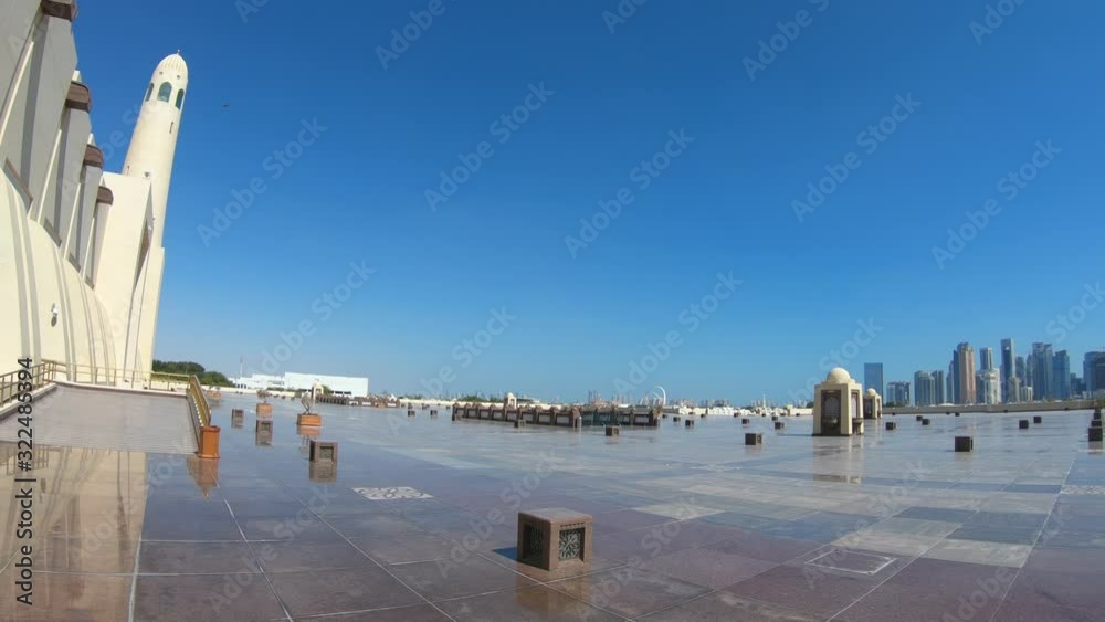 Scenic Doha Grand Mosque with minaret, mirroring on the outdoor marble ...